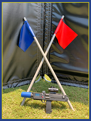 Crossed red and blue flags with a laser tag tagger in between.