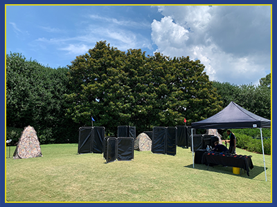 Laser Tag battlefield set up with barricades, and tents.
